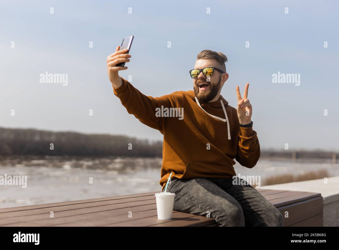 Bearded man enjoying spring and taking selfie picture on promenade by ...
