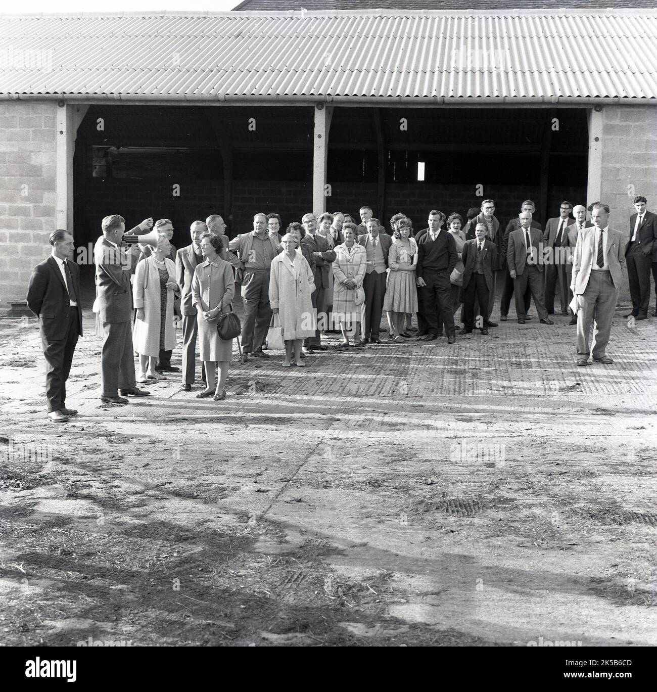 1964, historical, group of men and women in a farmyard on a visit to ...