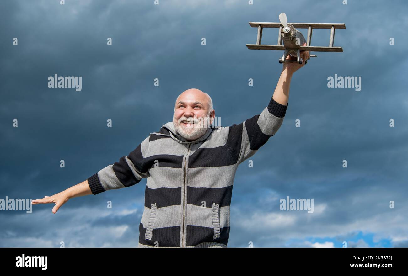 happy retirement. excited granddad with toy. retired old man outdoor ...