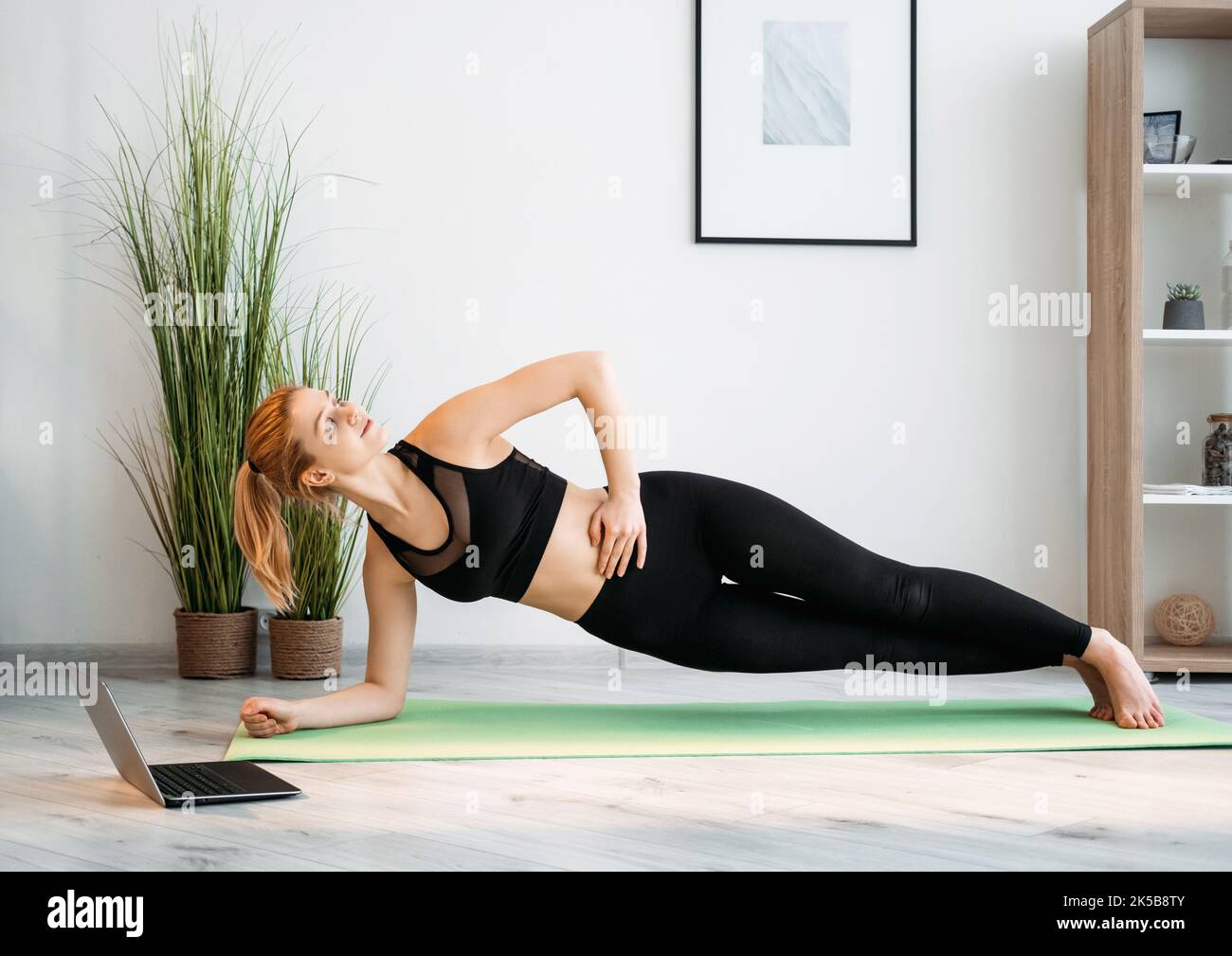 home training fitness online woman plank laptop Stock Photo - Alamy