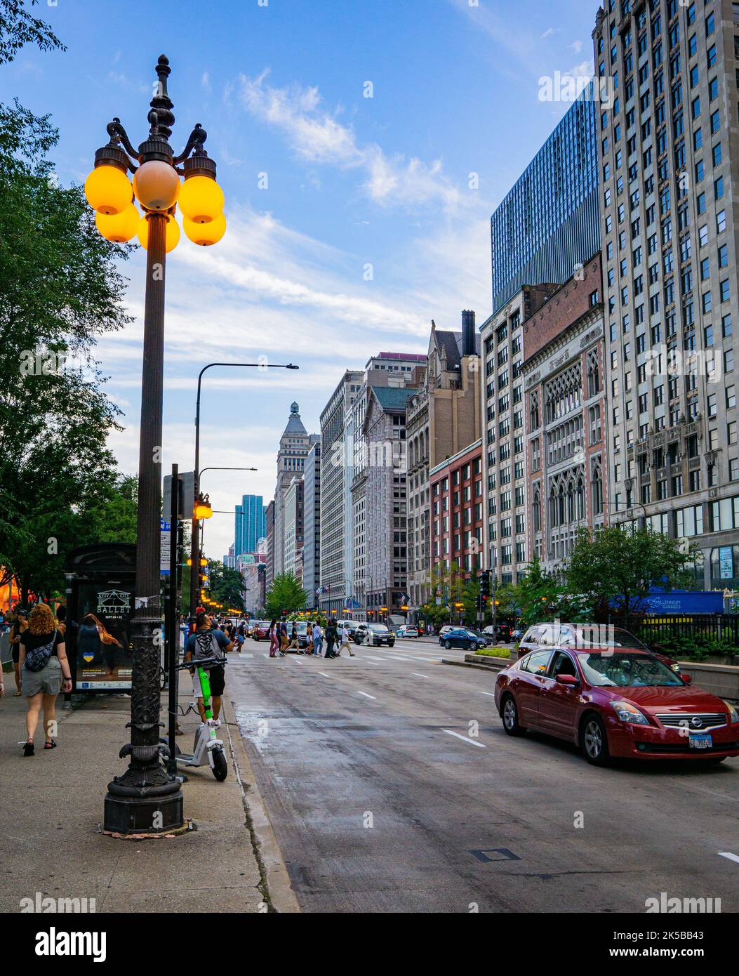 A Chicago city street public with lamp post and cars under buildings ...