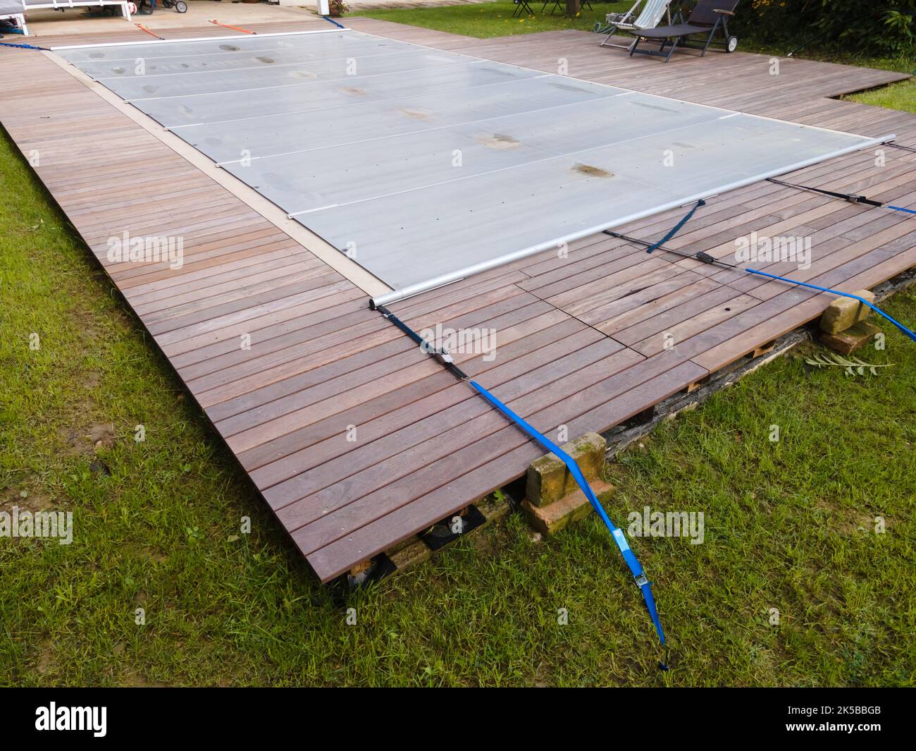 Drone photo of pool which is covered with grey pool tarpaulin, cover ...