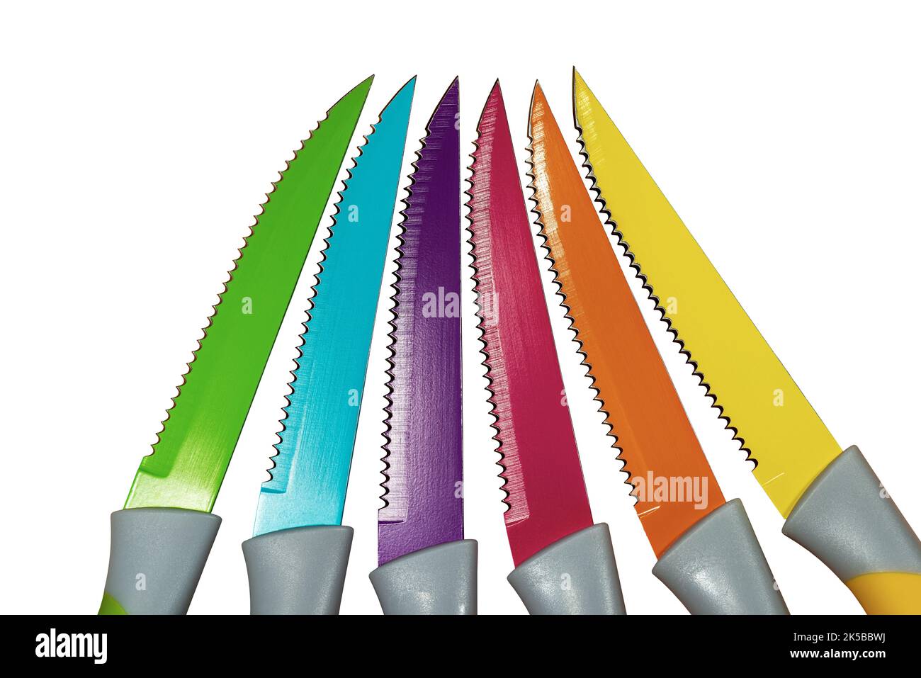 Close-up of set of six colored table knives (green, blue, purple, red ...
