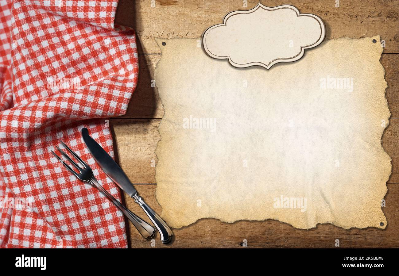 Wooden rustic table with a red and white checkered tablecloth, silver ...