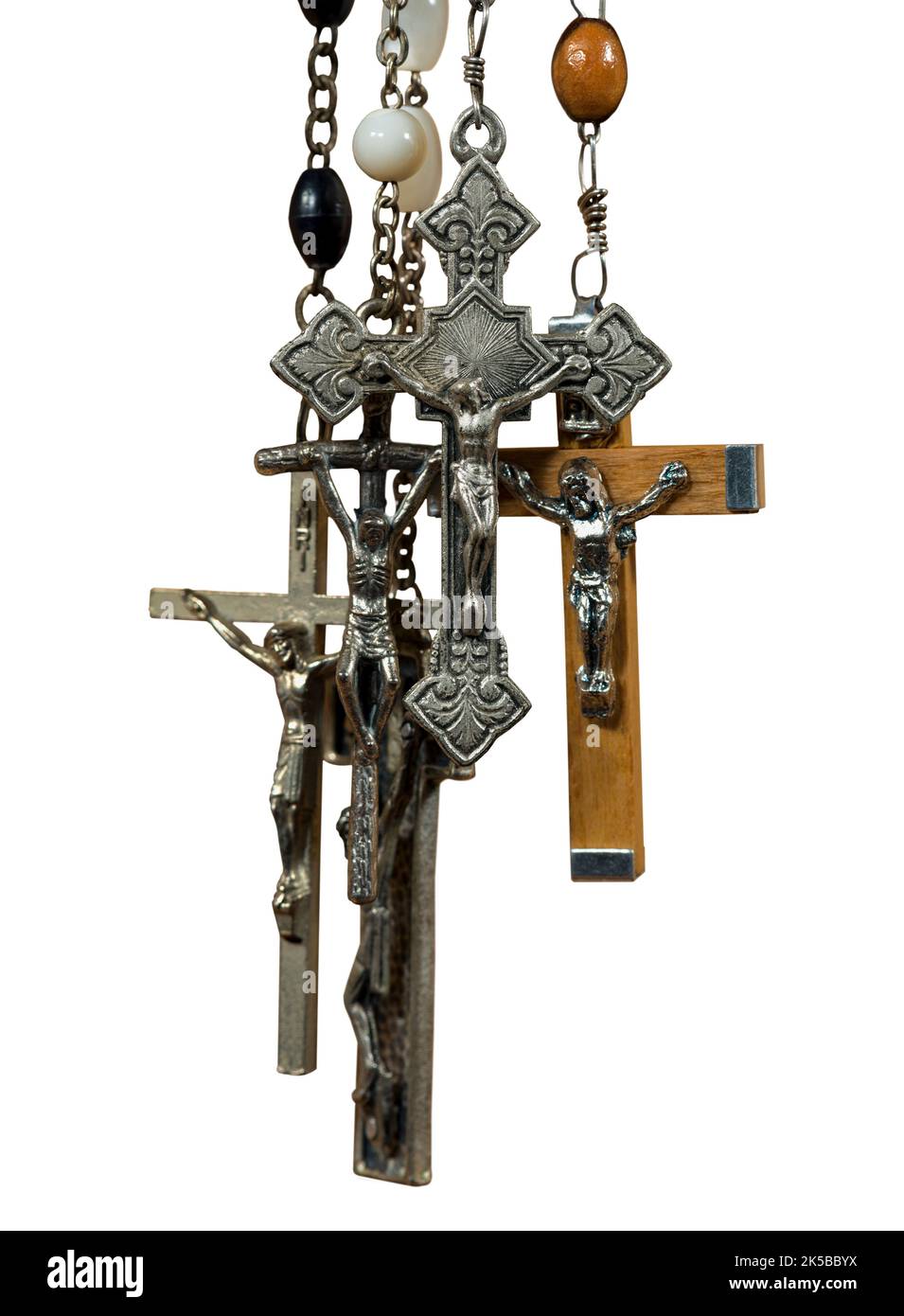 Close-up of a group of metal and wooden crucifixes and rosary beads ...