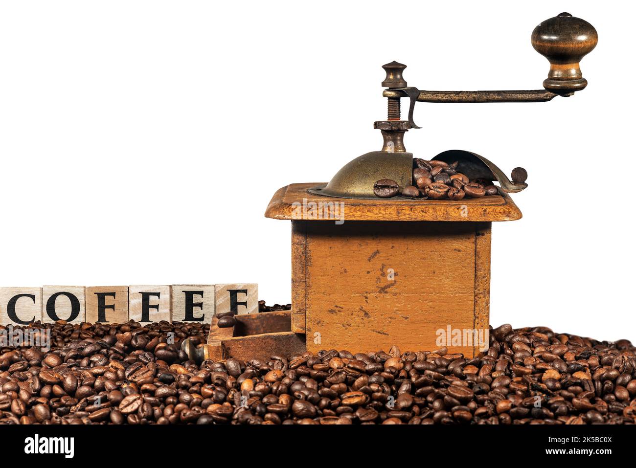 Old manual coffee grinder with roasted coffee beans and the text Coffee ...