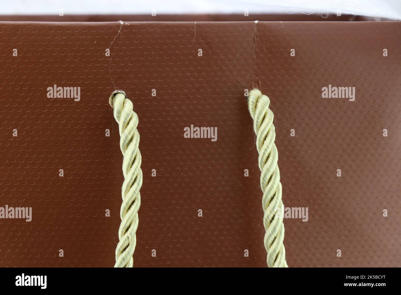 Small shopping bag made from cardboard with rope handle that gives ...