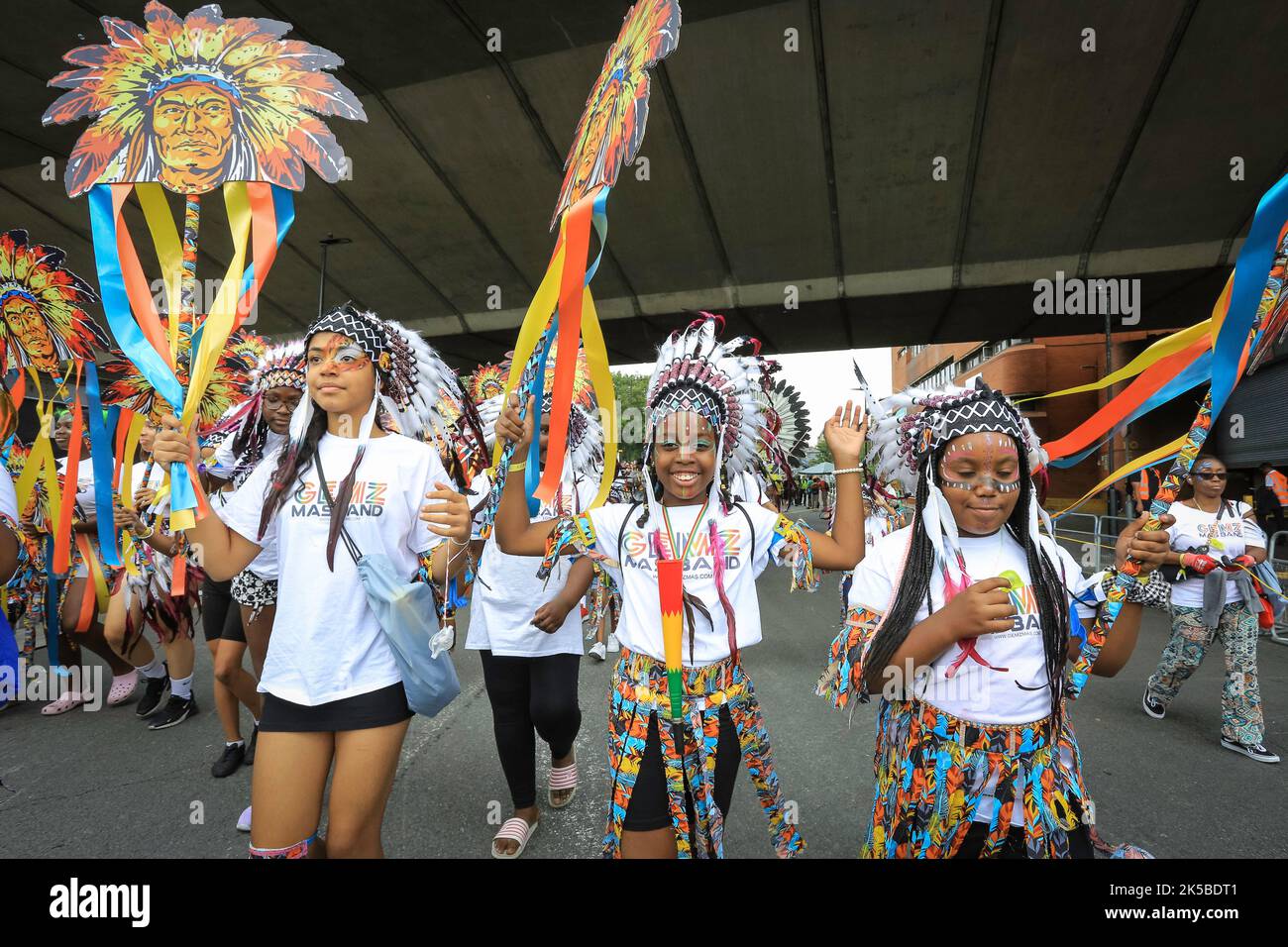 A children's group with Gemz Mas in colourful costumes participate at ...