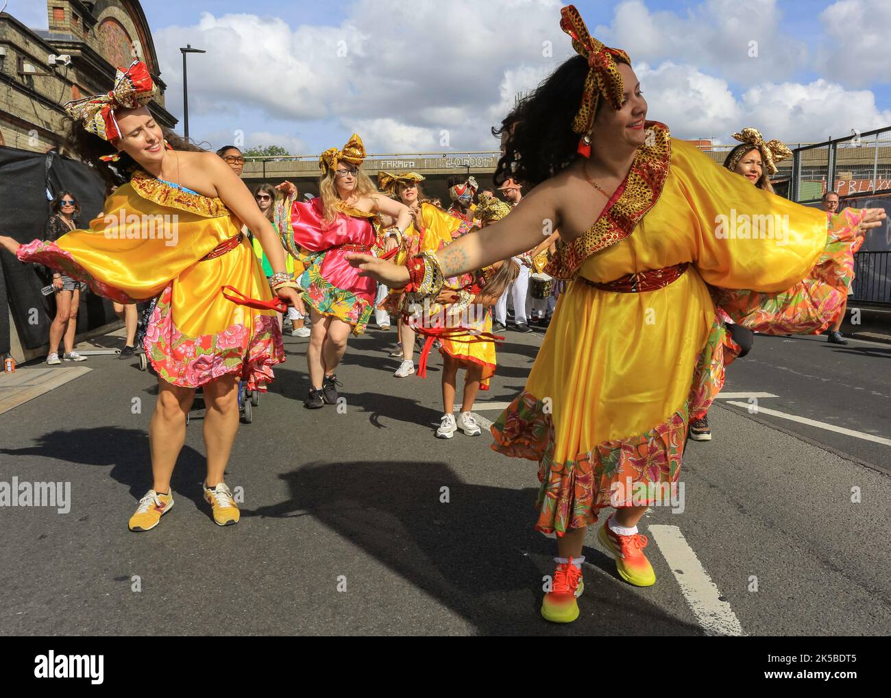 A dance group in colourful costumes participate at family day parade ...