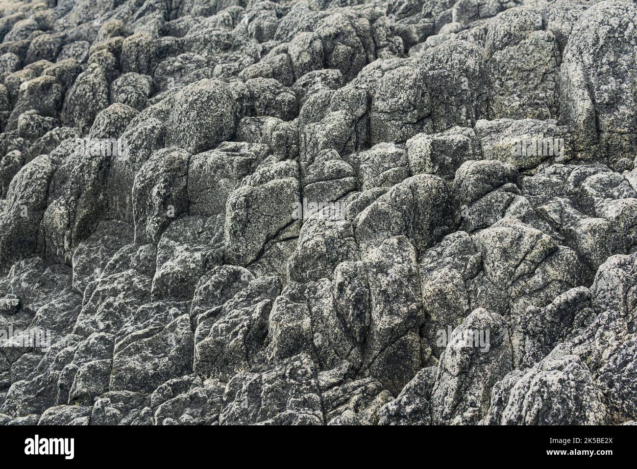 natural stone background, the remains of lava basalt columns form a ...