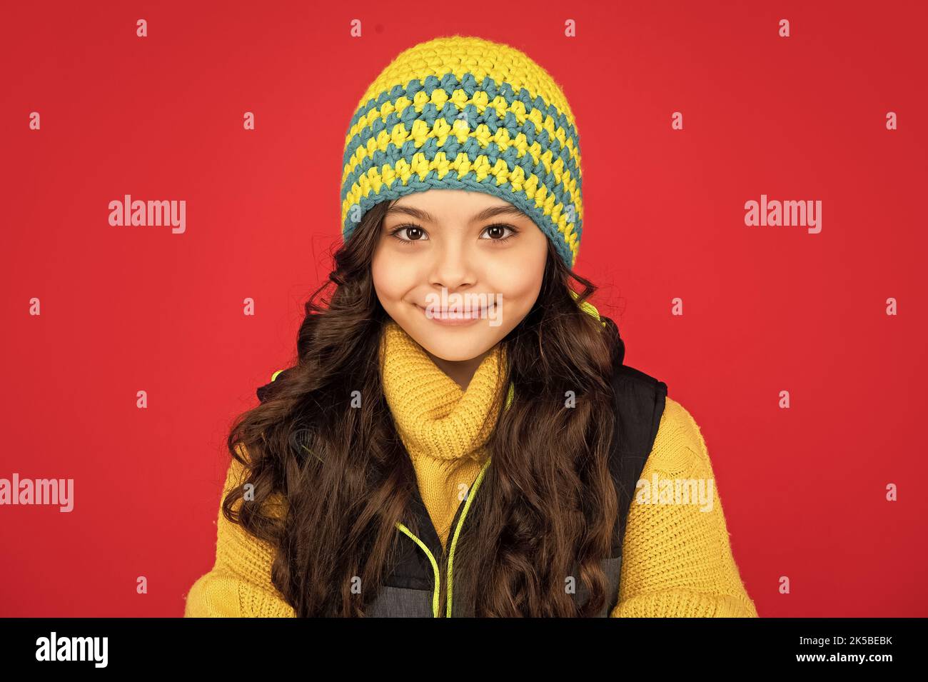 express positive emotion. winter fashion. smiling kid with curly hair ...