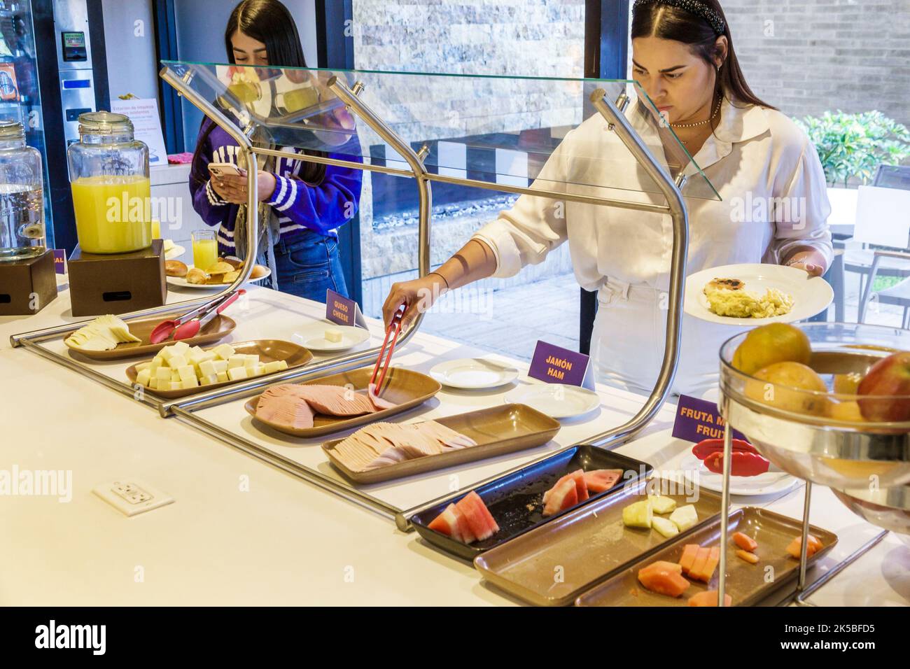 Woman women female self serve service buffet table bar fruit hi-res ...