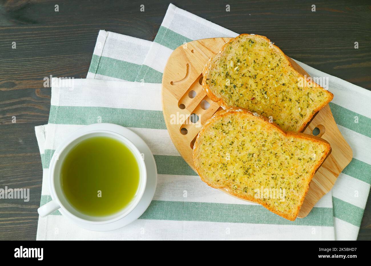 Garlic Butter Toasts on Breadboard with a Cup of Hot Green Tea n Black ...