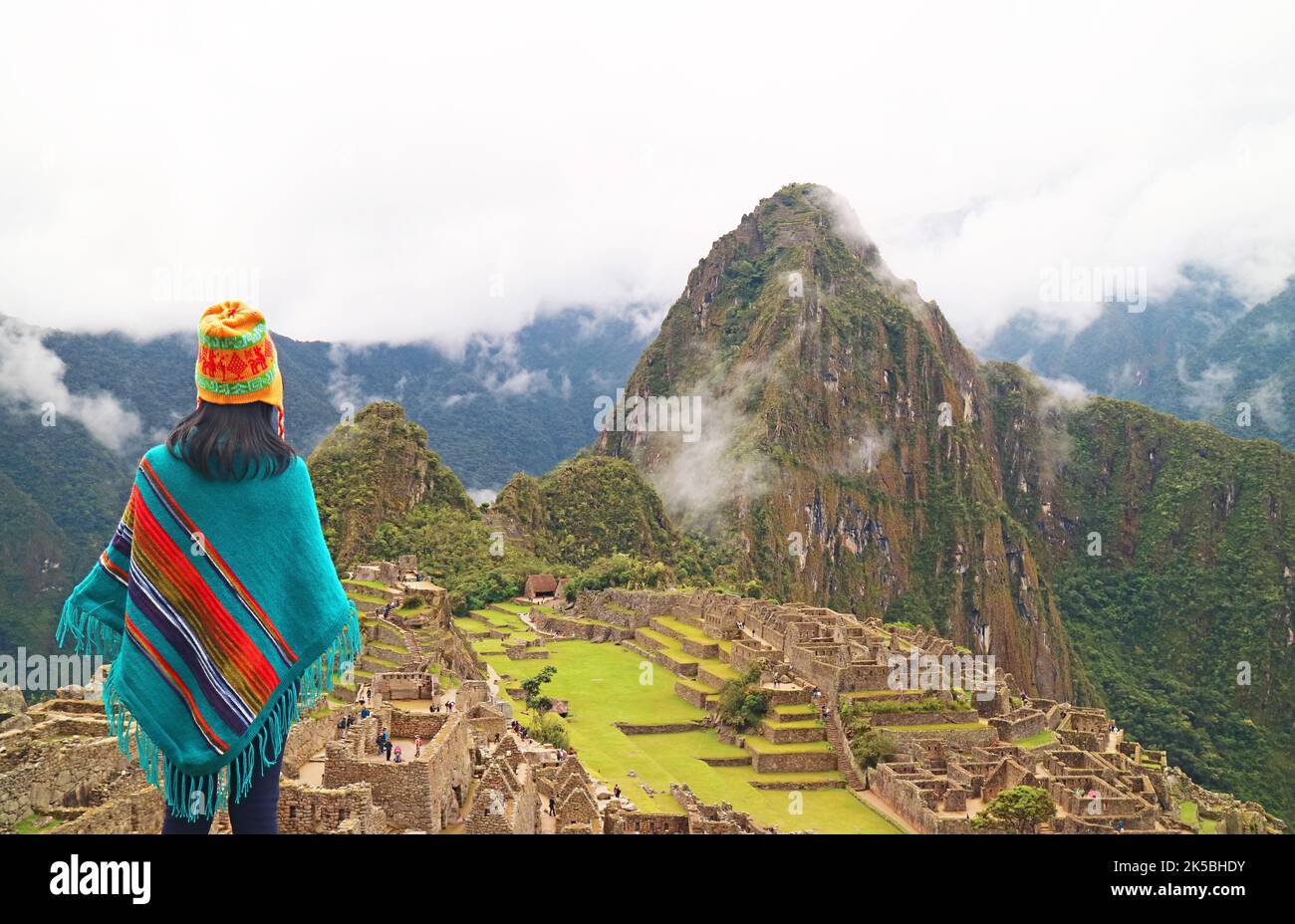 Female visitor impressed by spectacular ancient Inca ruins of Machu ...