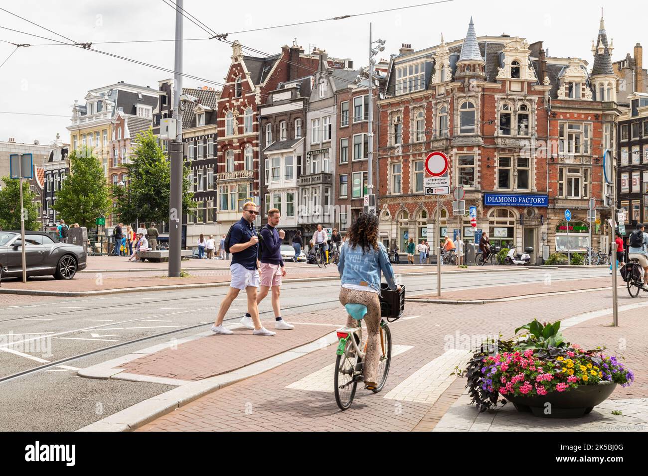Cyclist rides over the zebra crossing at a busy intersection in the ...