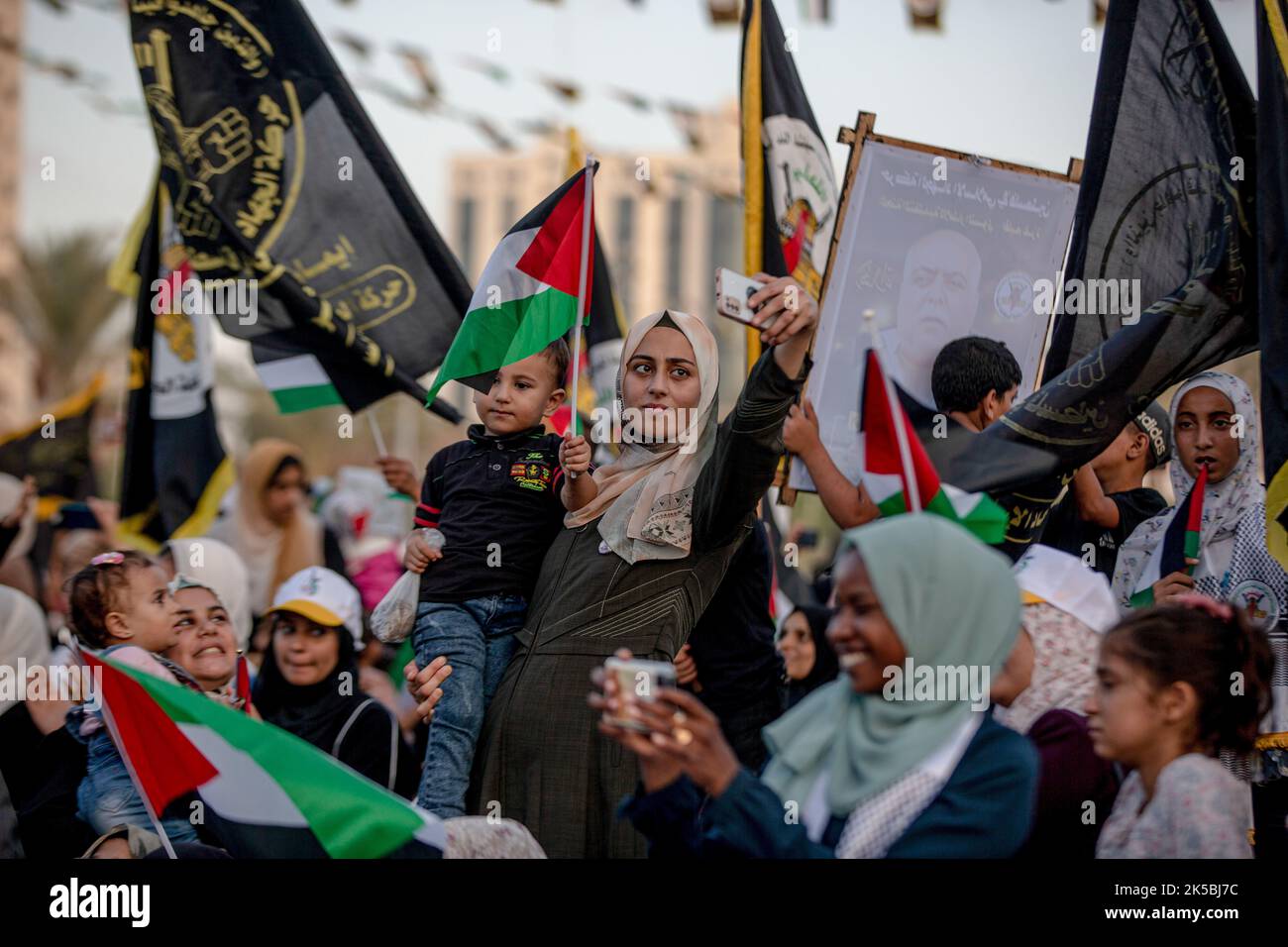 A Palestinian woman takes a selfie with her child, during a festival ...