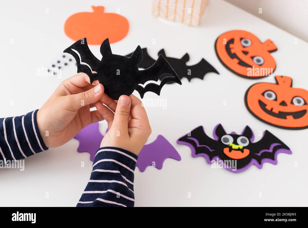 child making felt bats sitting at table Stock Photo - Alamy