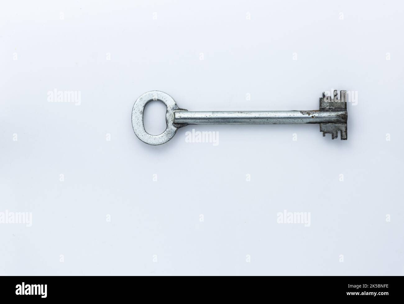 Old rusty key in the light gray background Stock Photo - Alamy