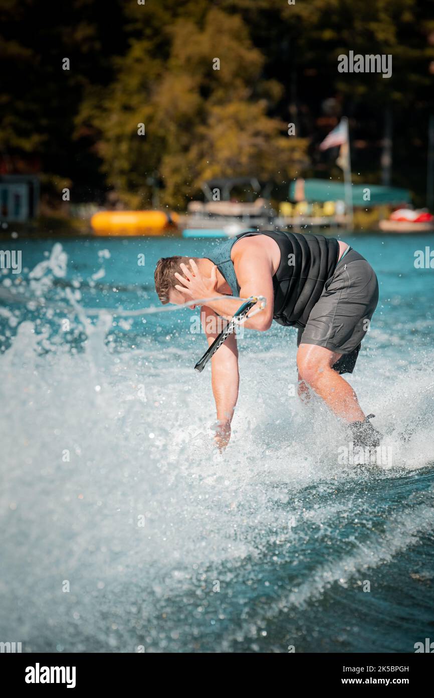 The vertical view of a man releasing the rope while wakeboarding Stock ...