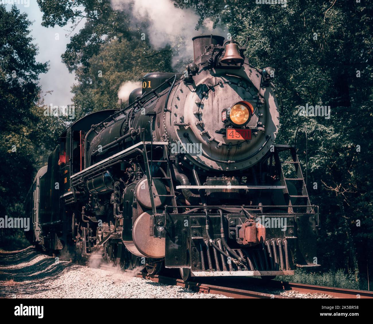 A frontal view of the vintage train on the railways passing through the ...