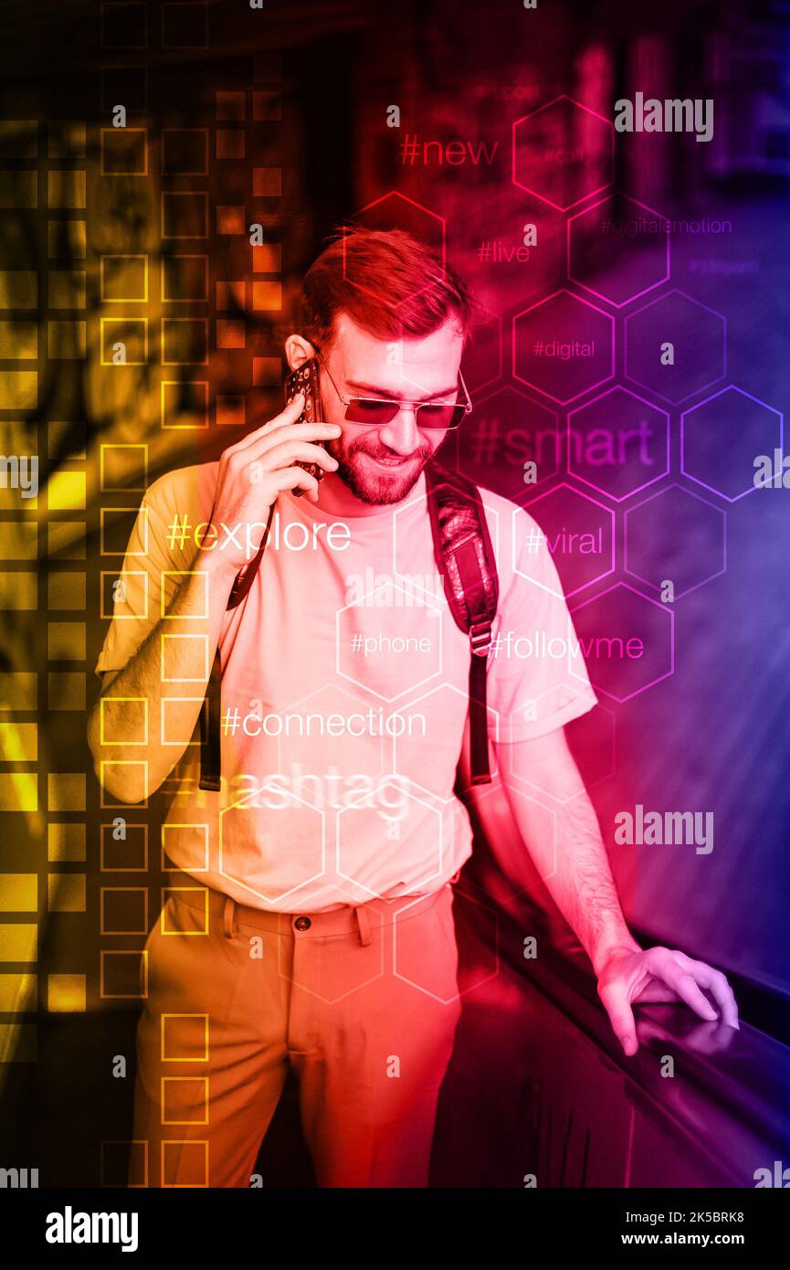 Happy young man talk on smartphones while standing on escalator. Modern ...