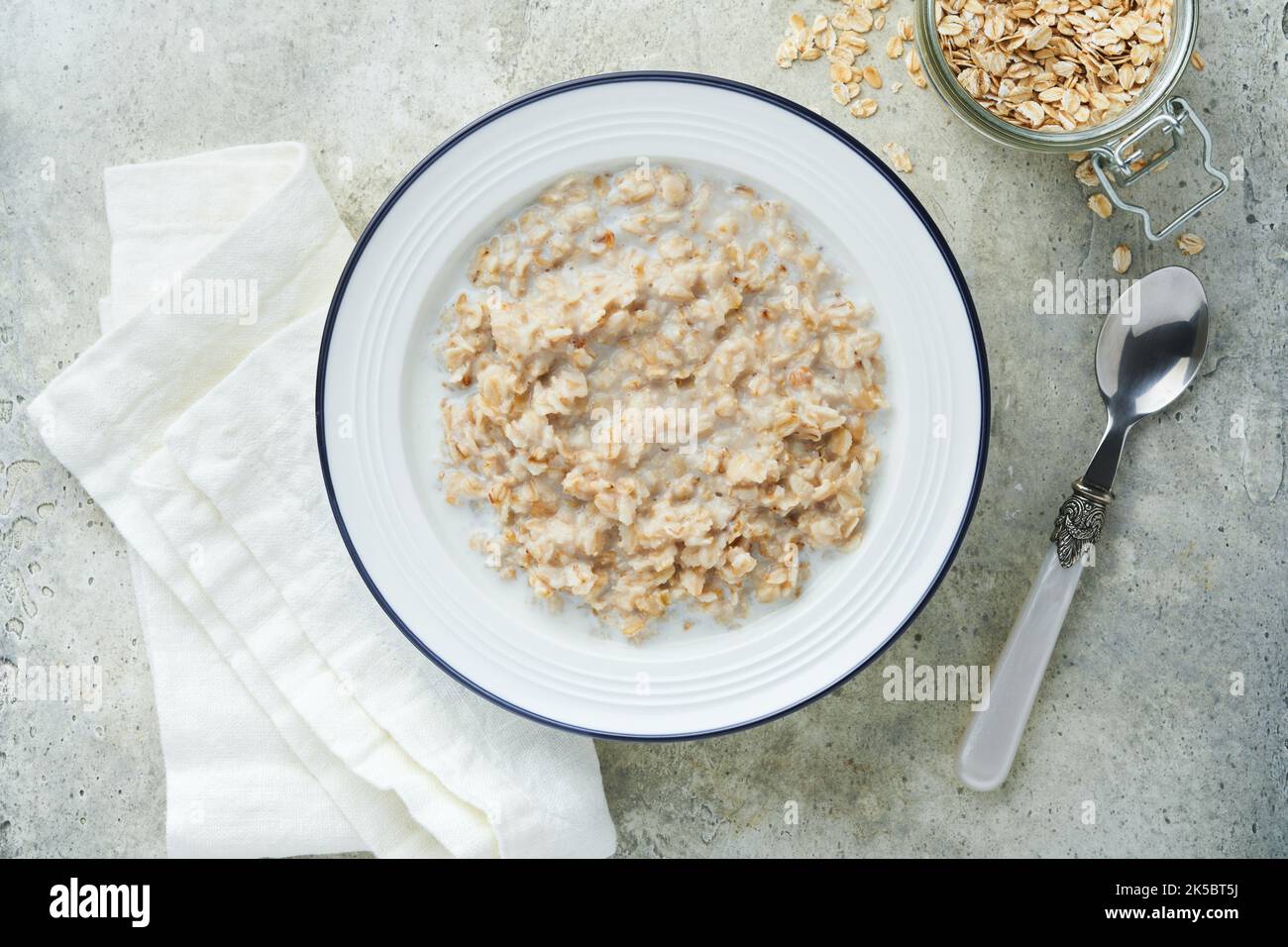 Oatmeal. Bowl of oatmeal porridge with strawberry, almond and milk on ...