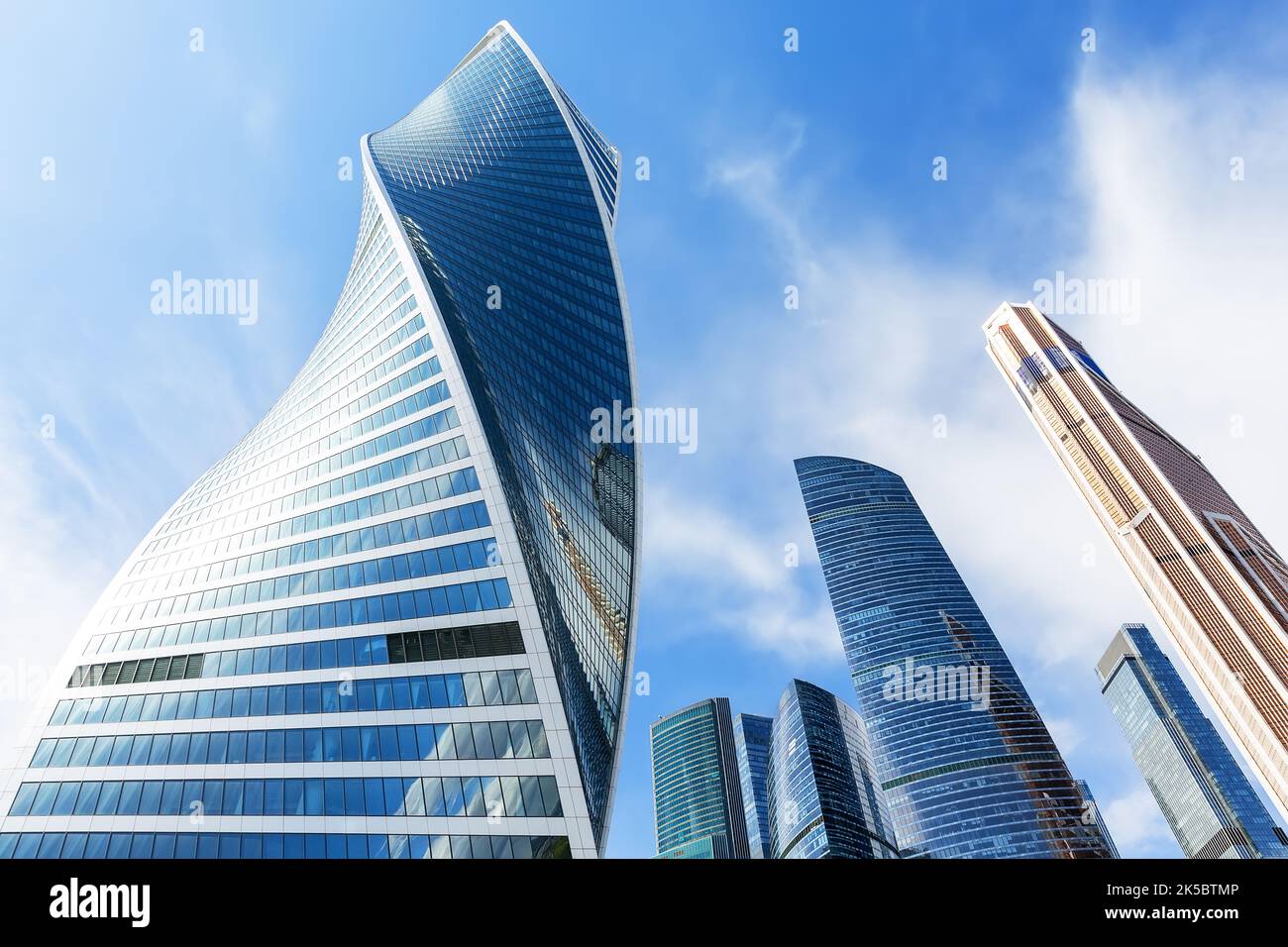 Modern glass silhouettes of skyscrapers in the city. Bottom view of ...