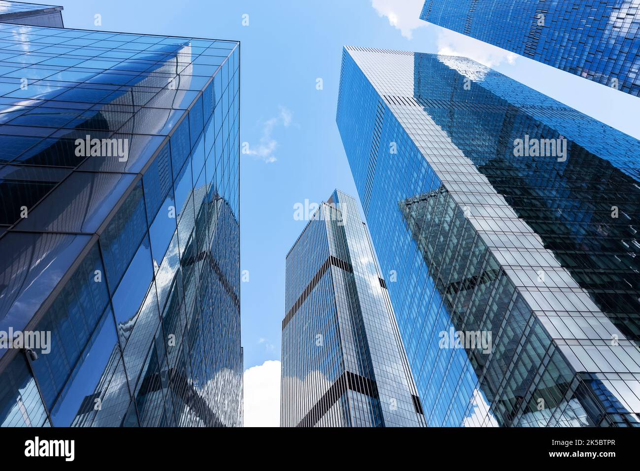 Modern glass silhouettes of skyscrapers in the city. Bottom view of ...