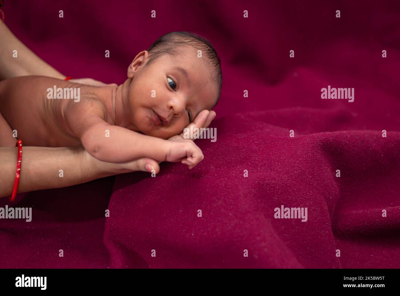 newly born baby laying at mother palm with cute facial expression from ...