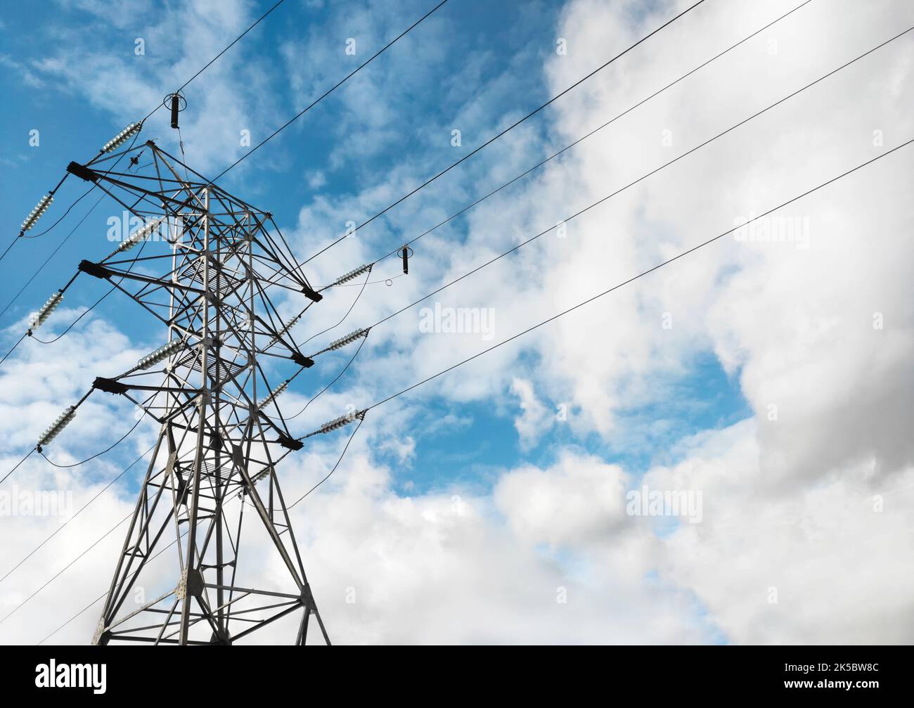 Tower of Electrical power lines on blue cloudy sky background Stock ...