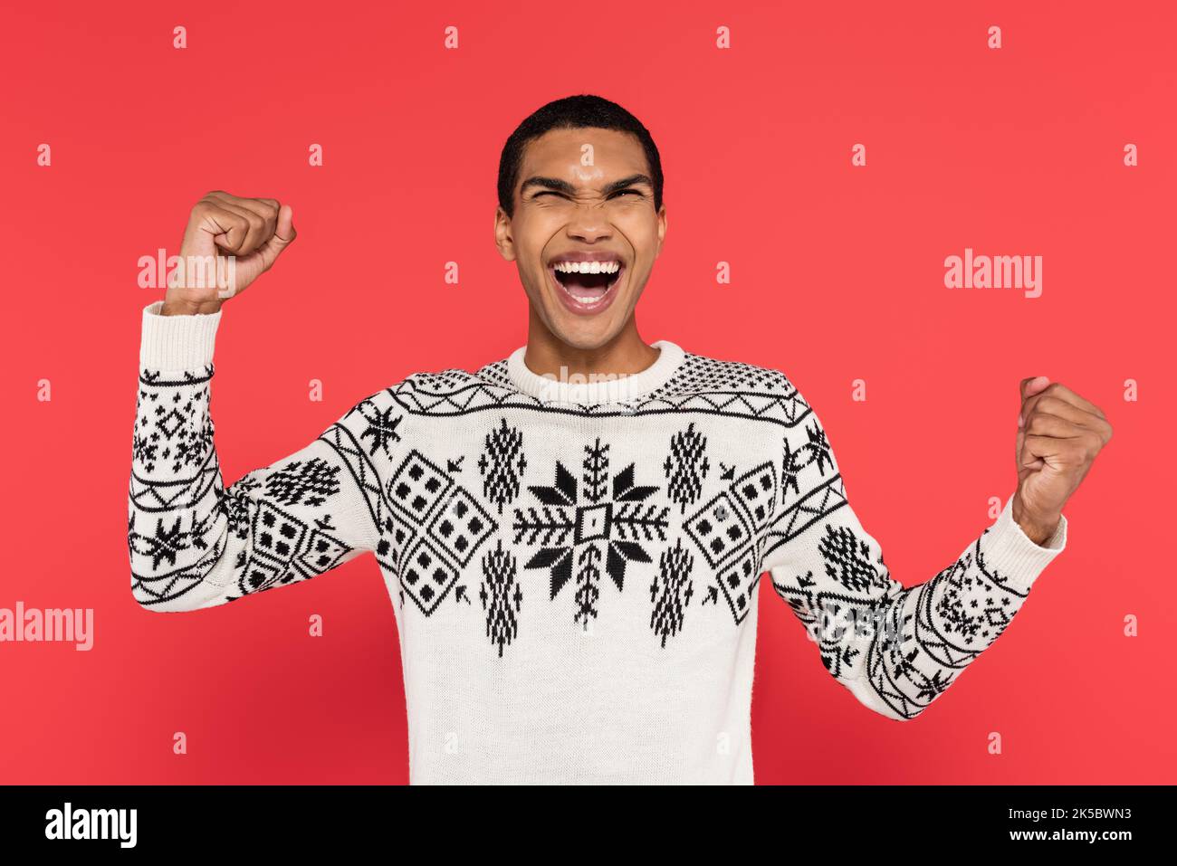 overjoyed african american man with closed eyes showing triumph gesture ...