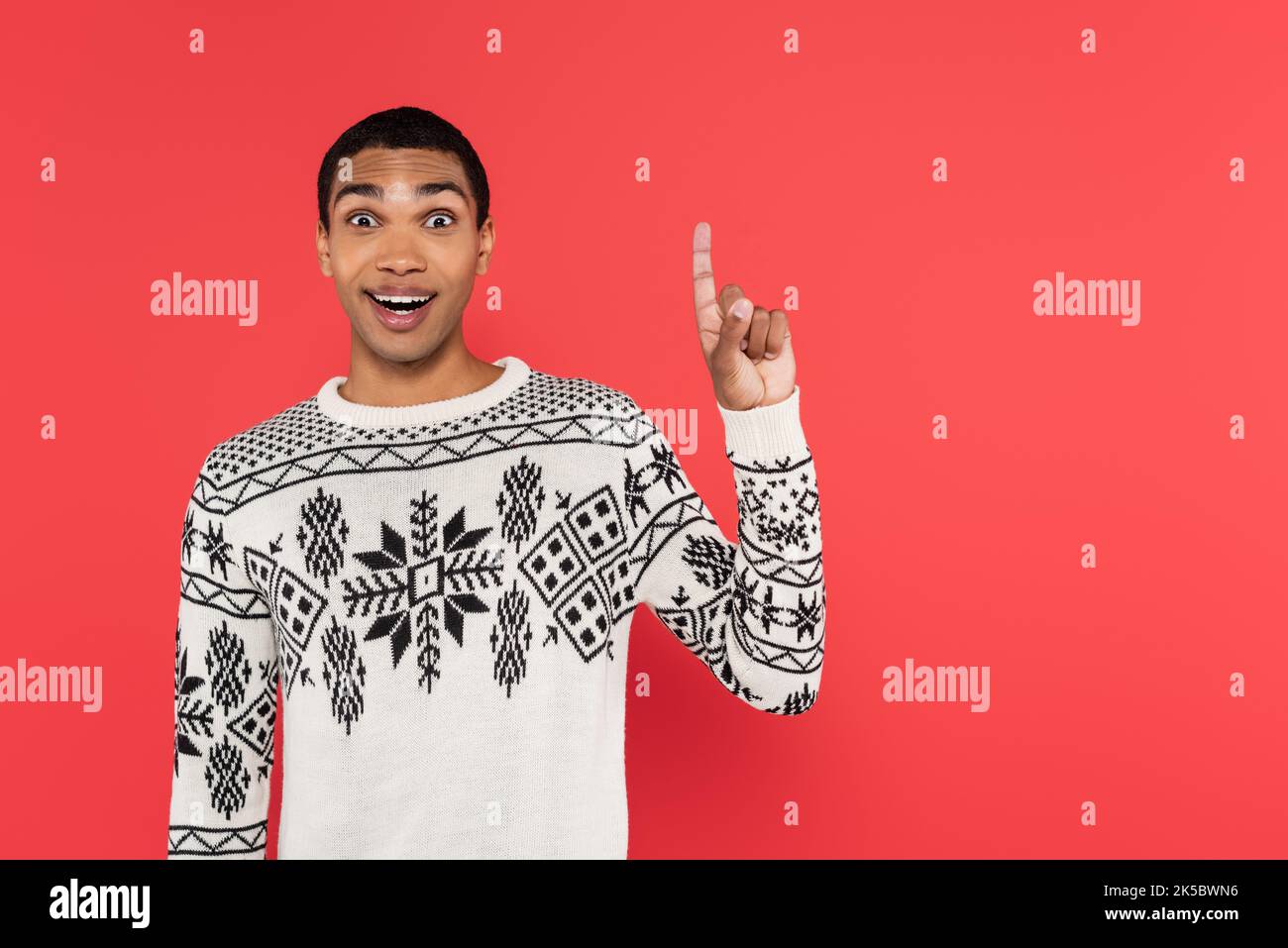 cheerful african american man in white sweater with winter pattern ...
