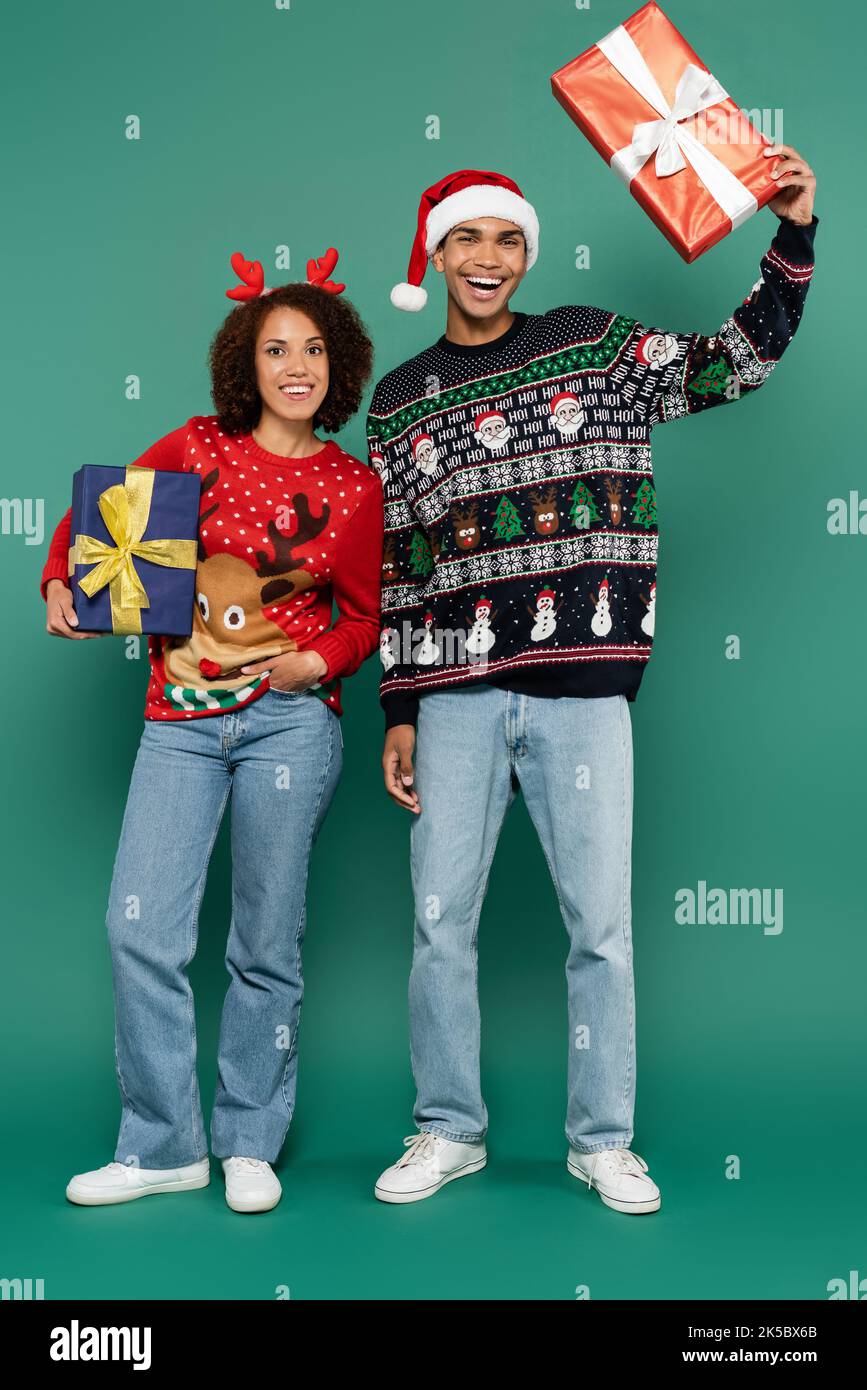 excited african american couple in santa hat and reindeer horns ...