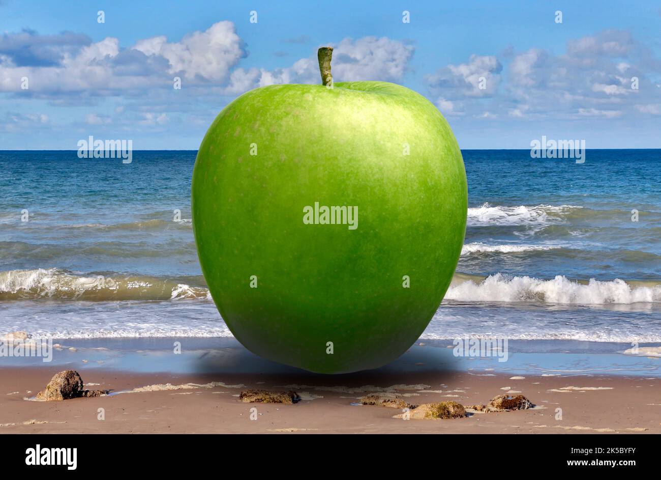 Surreal apple on beach Stock Photo - Alamy
