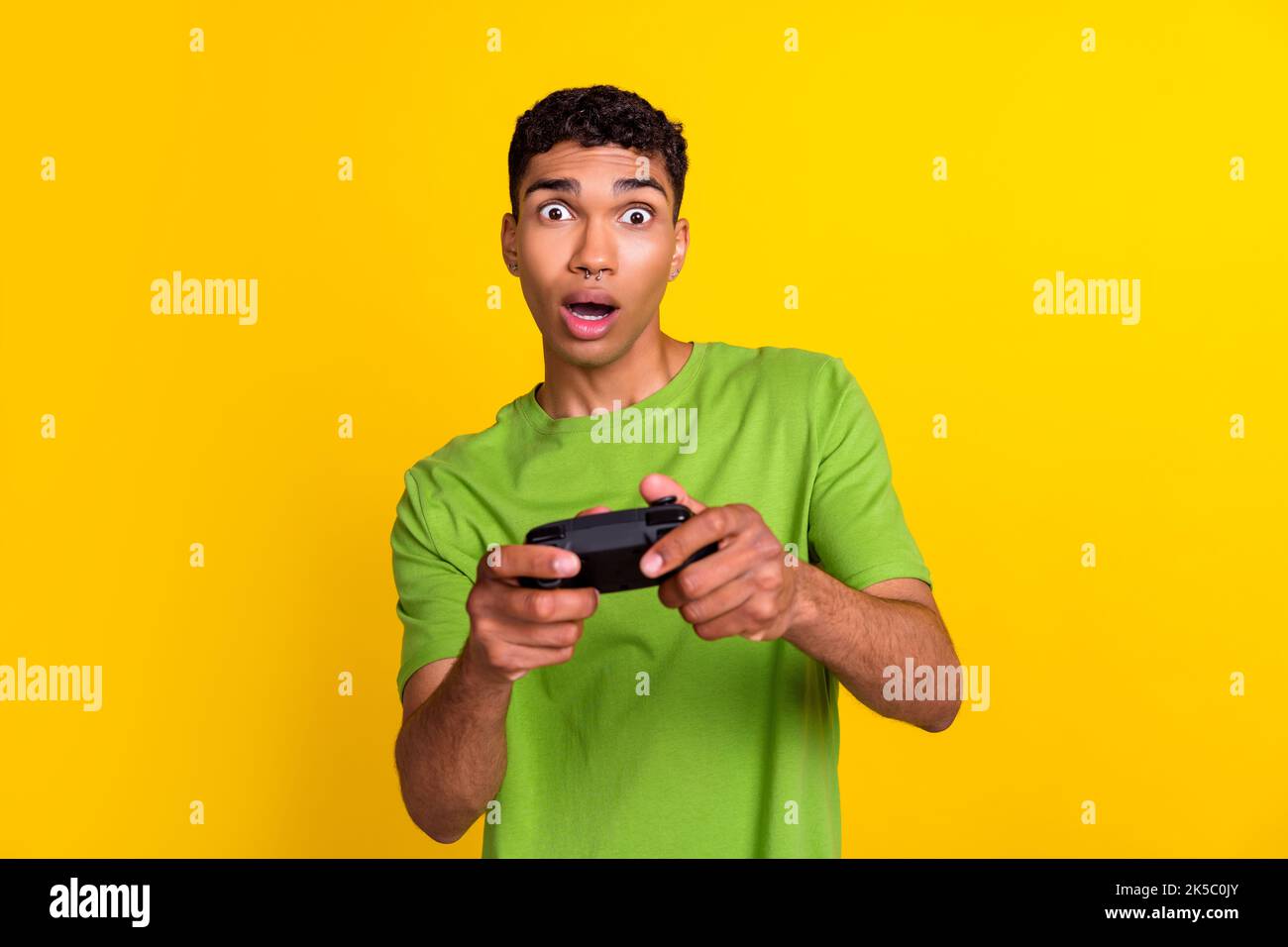 Photo of young handsome attractive student man hold wireless joystick ...