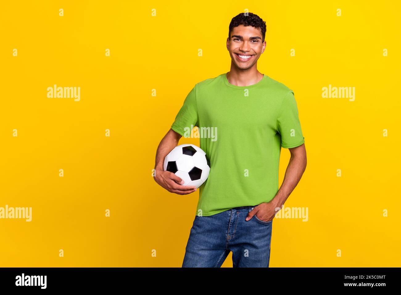 Photo portrait of attractive young man hold football soccer ball ...