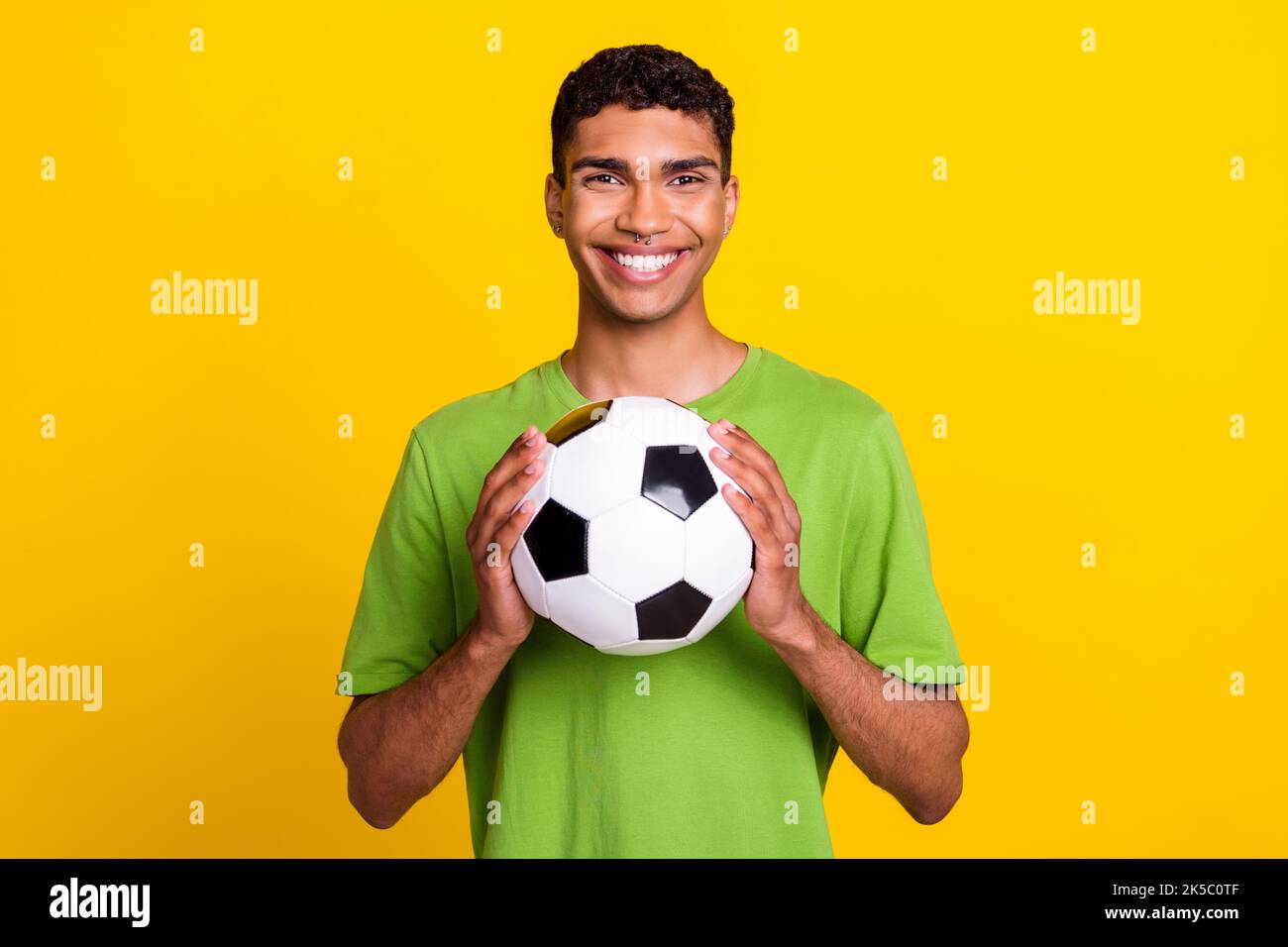 Photo of young attractive handsome smiling man hold football ball ...