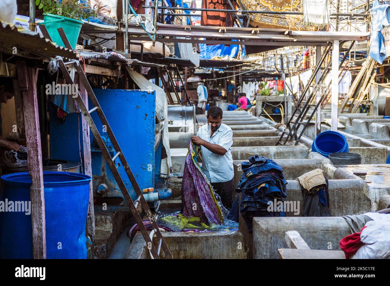 Mumbai, Maharashtra, India : A dhobi washerman works at an individual ...