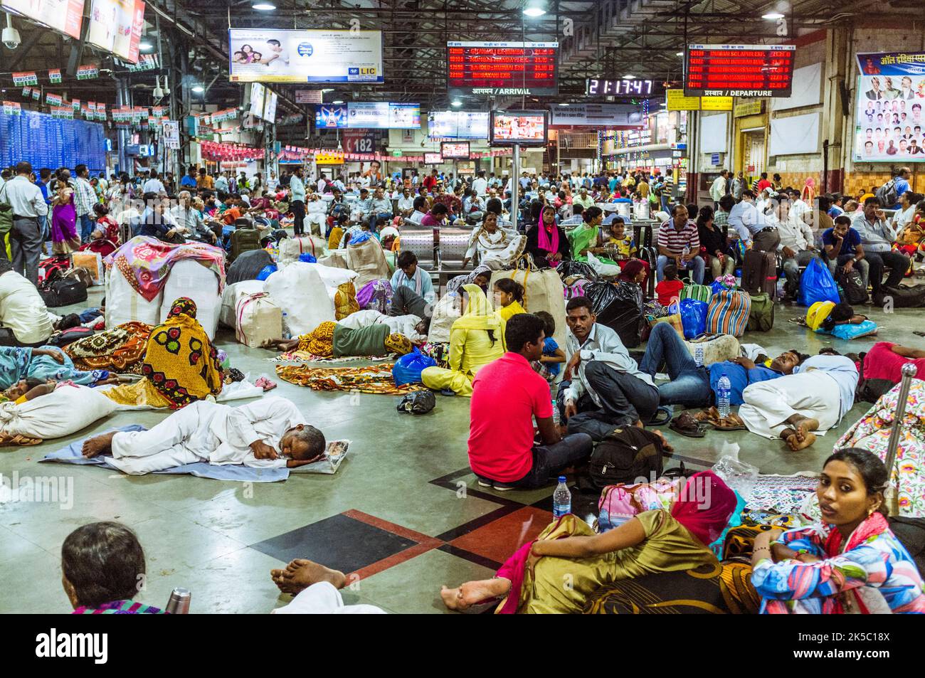 Mumbai, Maharashtra, India : Travellers wait for their trains inside ...