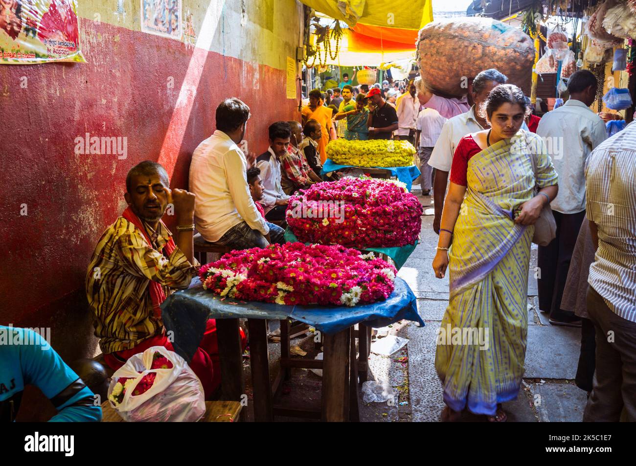 Mysore, Karnataka, India : A woman walks past flower stalls at Devaraja ...