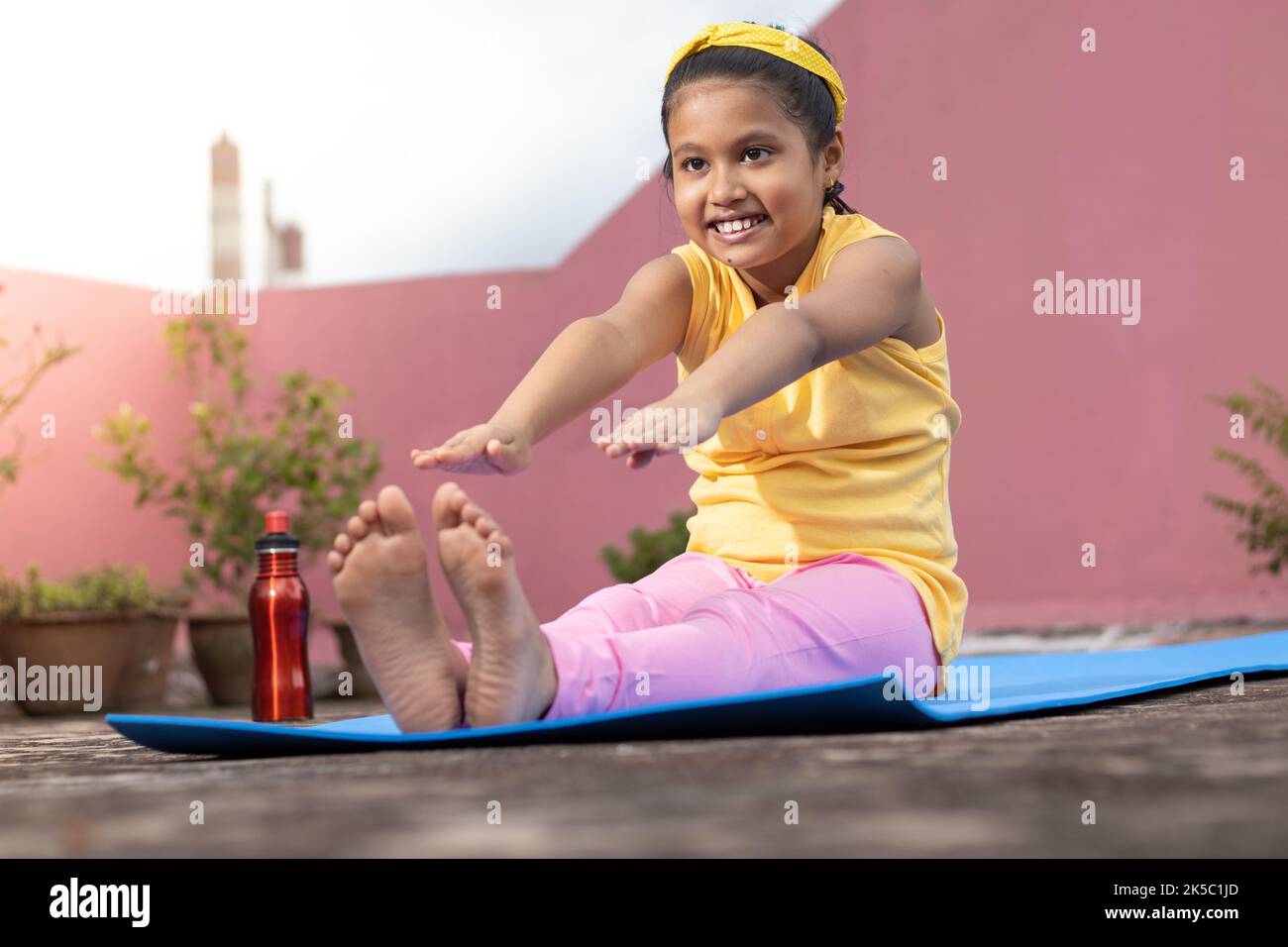 Happy indian girl child doing yoga hi-res stock photography and images ...