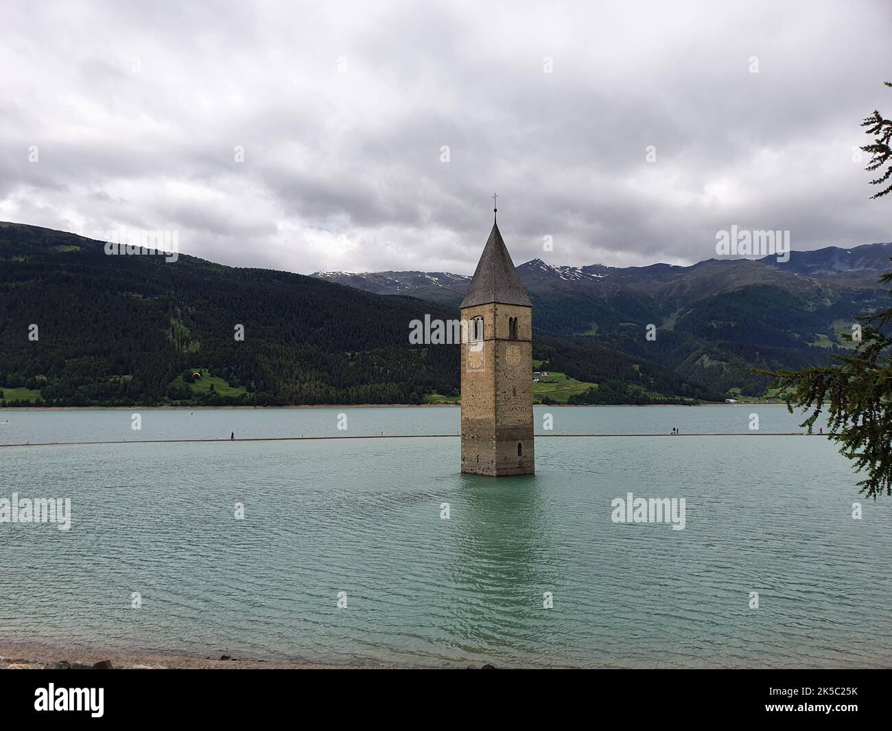 the bell tower of Curon submerged in Lake Resia in the Vinschgau Valley ...