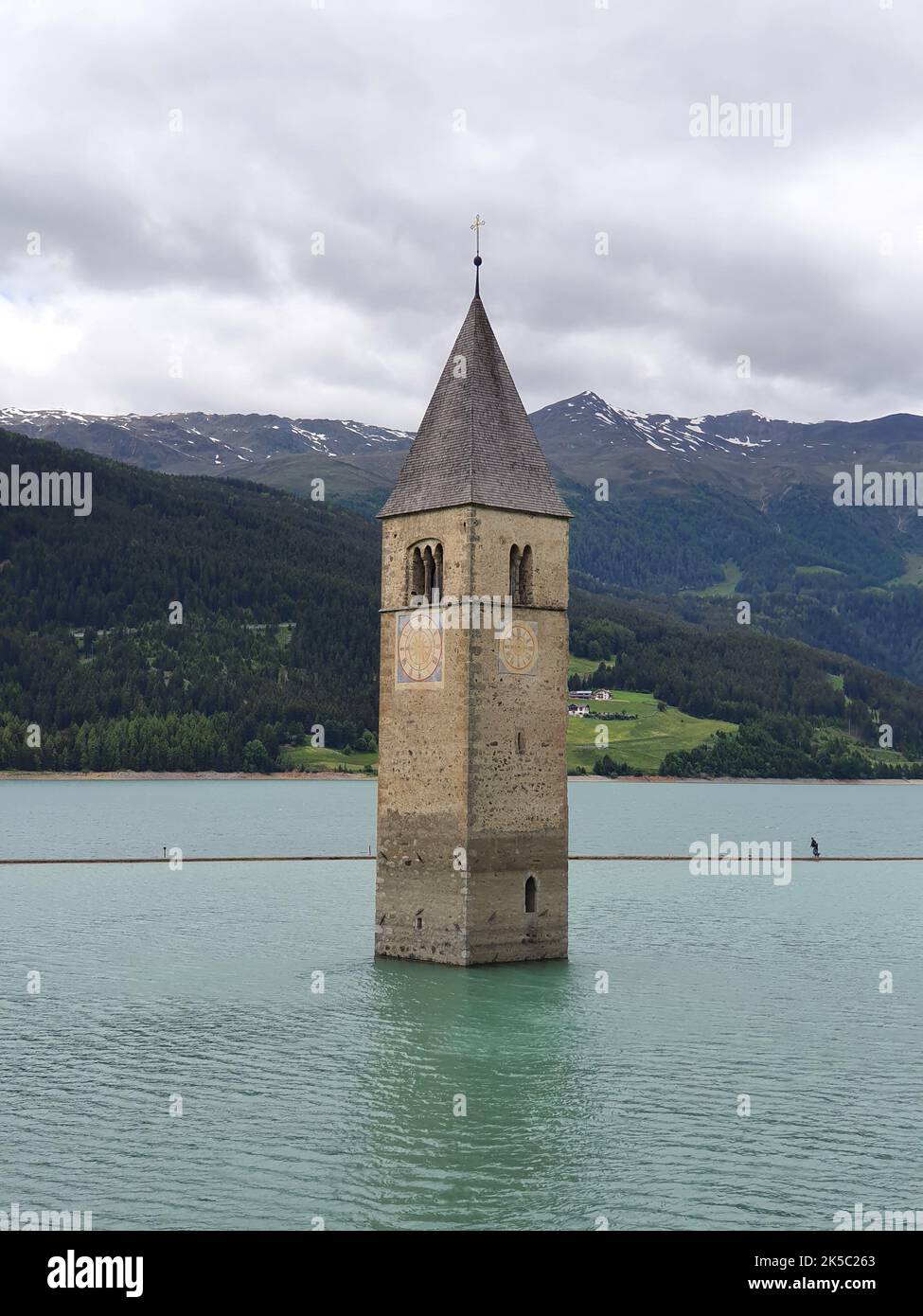 the bell tower of Curon submerged in Lake Resia in the Vinschgau Valley ...