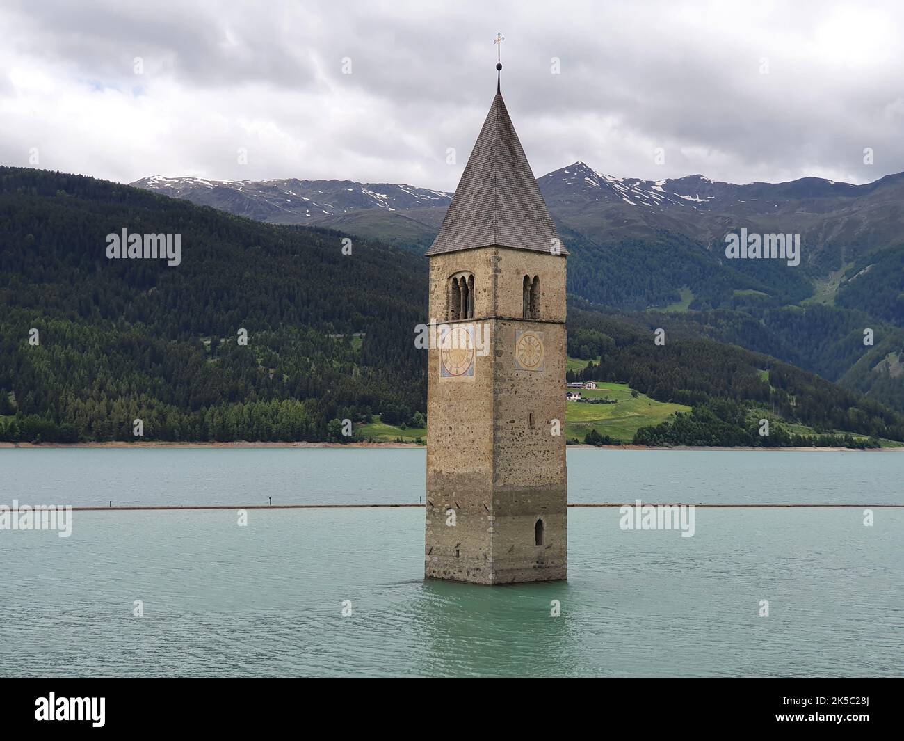 the bell tower of Curon submerged in Lake Resia in the Vinschgau Valley ...