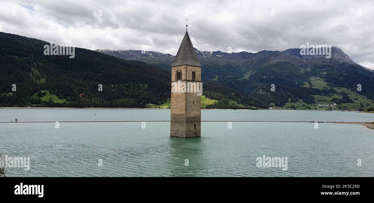 the bell tower of Curon submerged in Lake Resia in the Vinschgau Valley ...