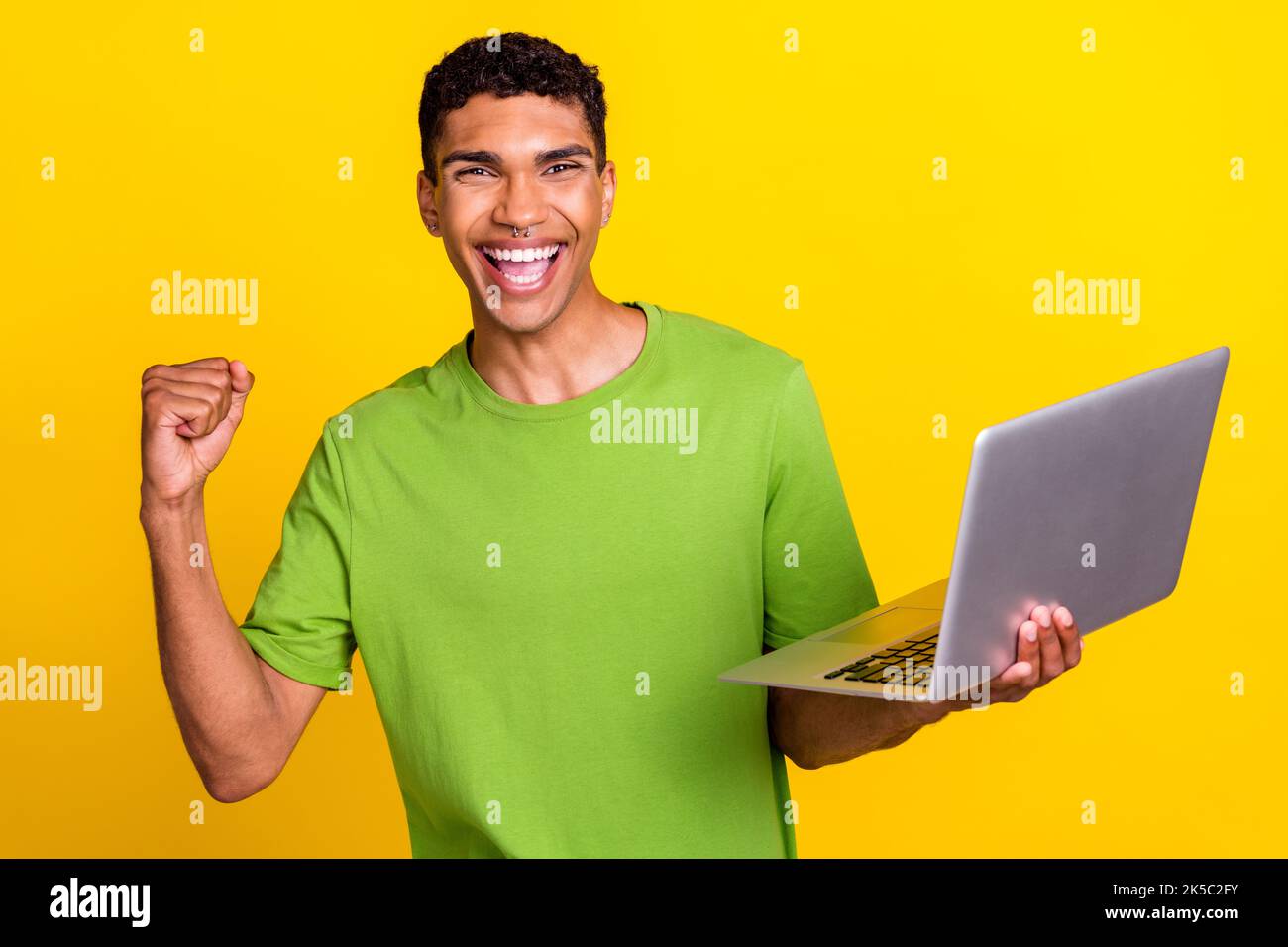 Photo of young attractive positive good mood man celebrate fist up yeah ...