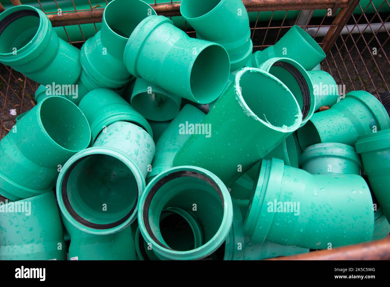 different green plastic drainpipes in a pile Stock Photo - Alamy