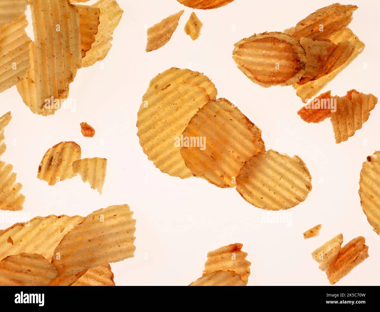 Clean background crinkle cut potato crisps in close up, food snack ...