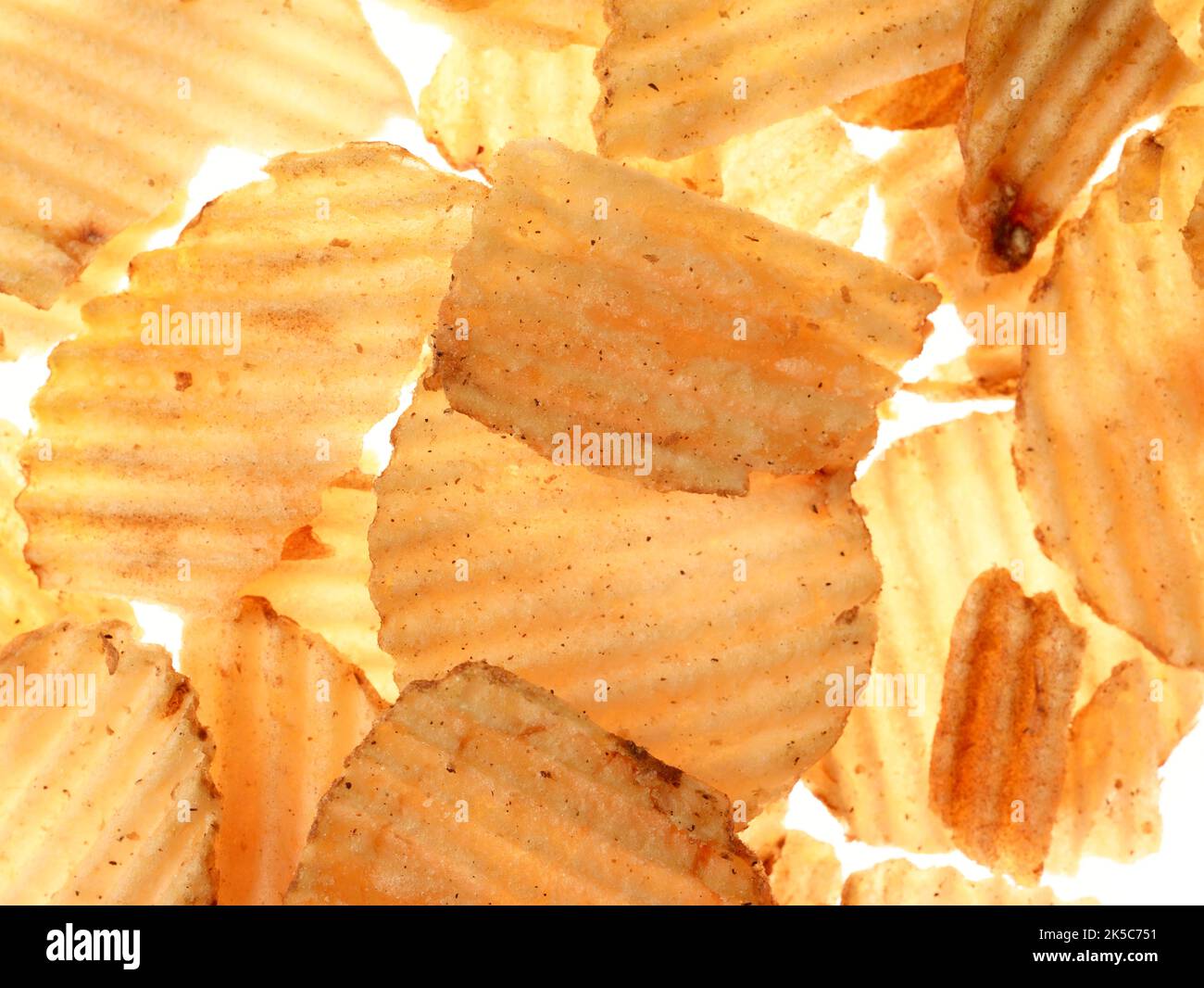 Clean background crinkle cut potato crisps in close up, food snack ...
