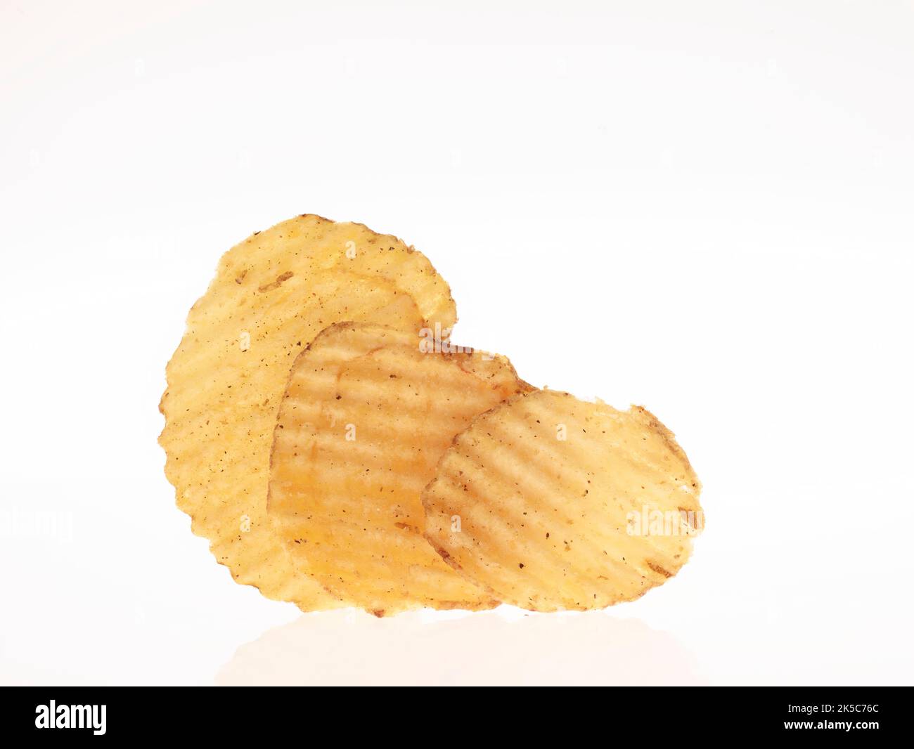 Clean background crinkle cut potato crisps in close up, food snack ...